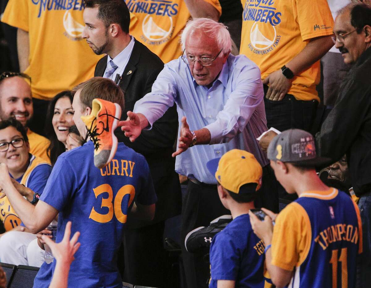 Presidential candidate Bernie Sanders arrives at halftime
