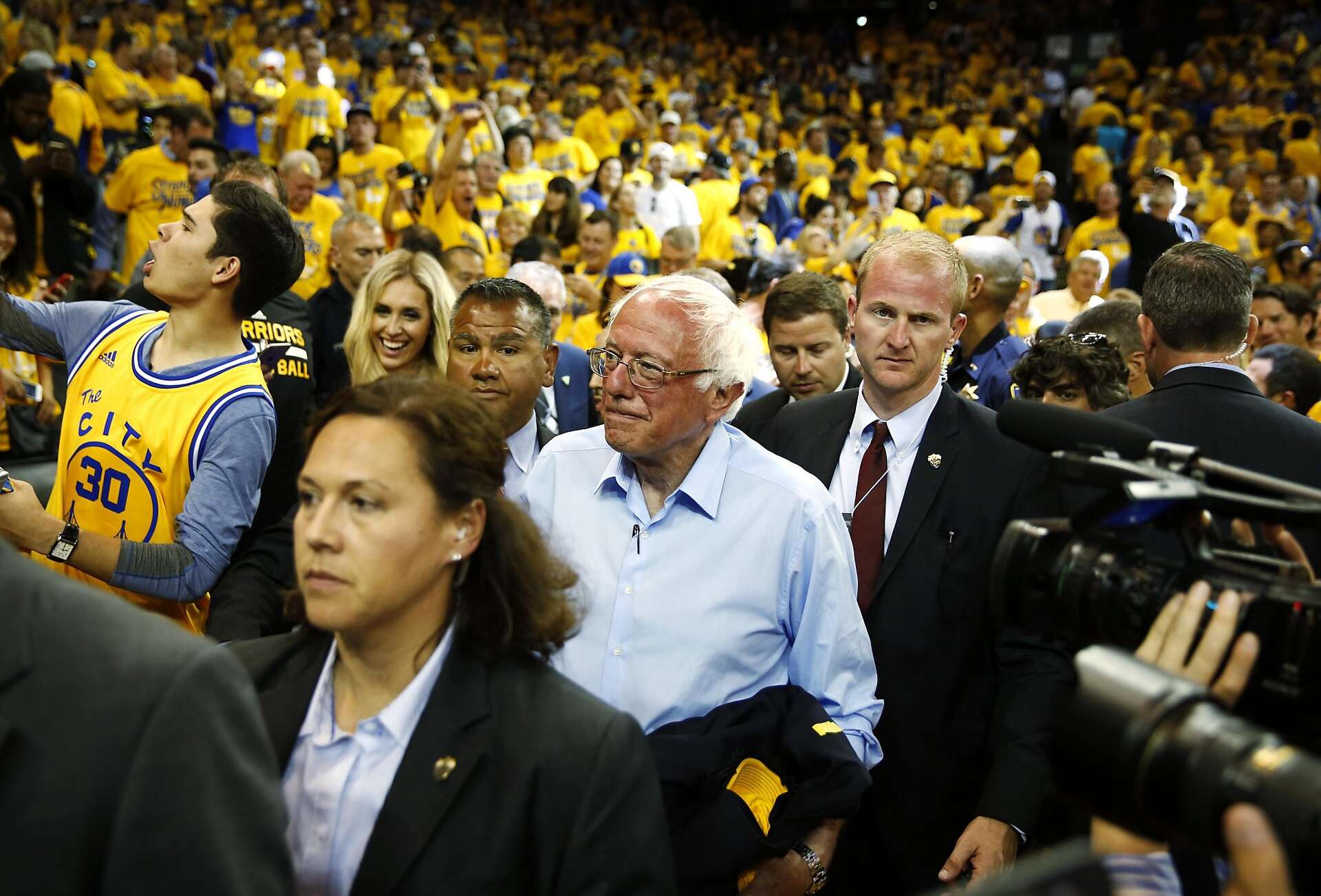 Presidential candidate Bernie Sanders arrives at halftime