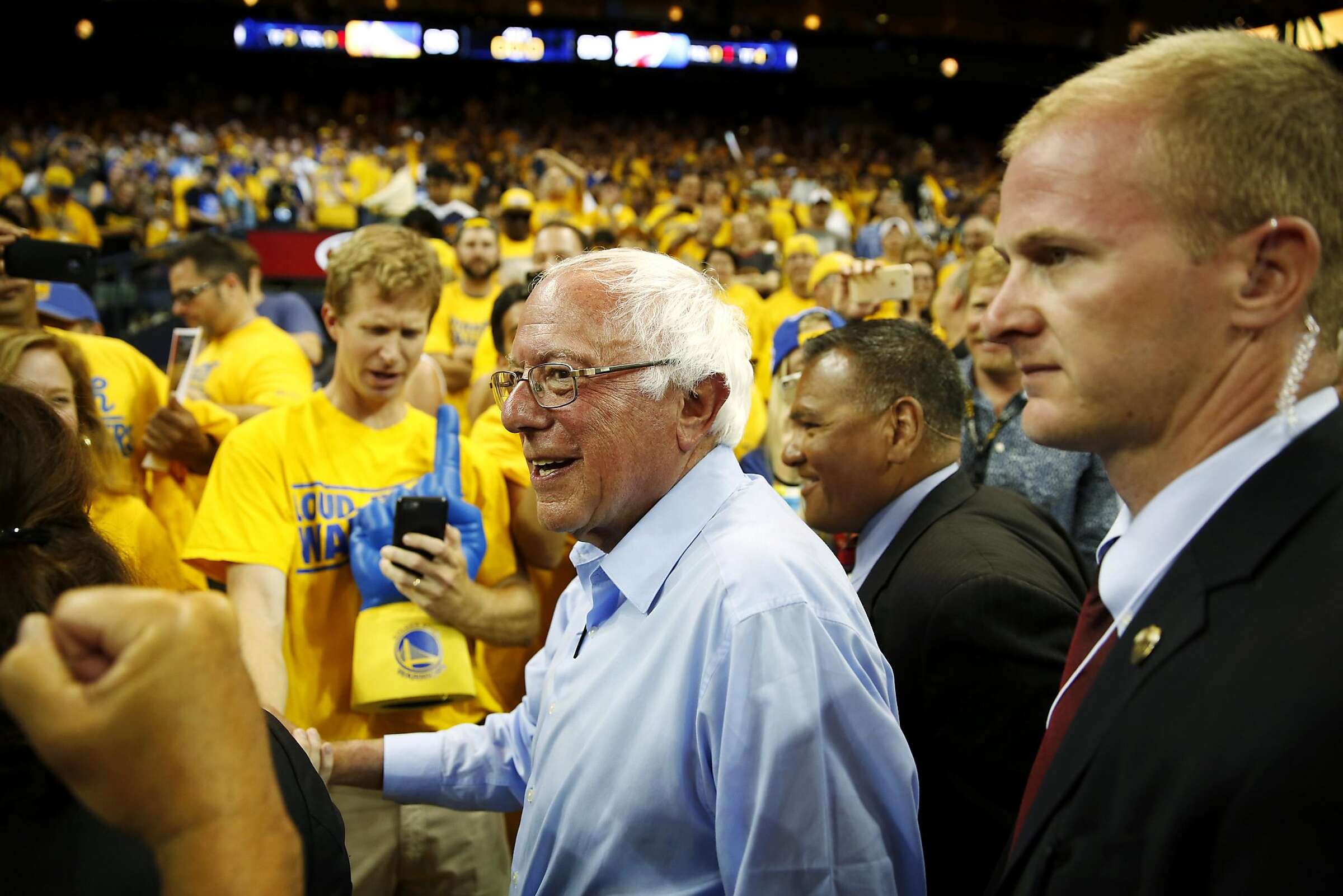 Presidential candidate Bernie Sanders arrives at halftime