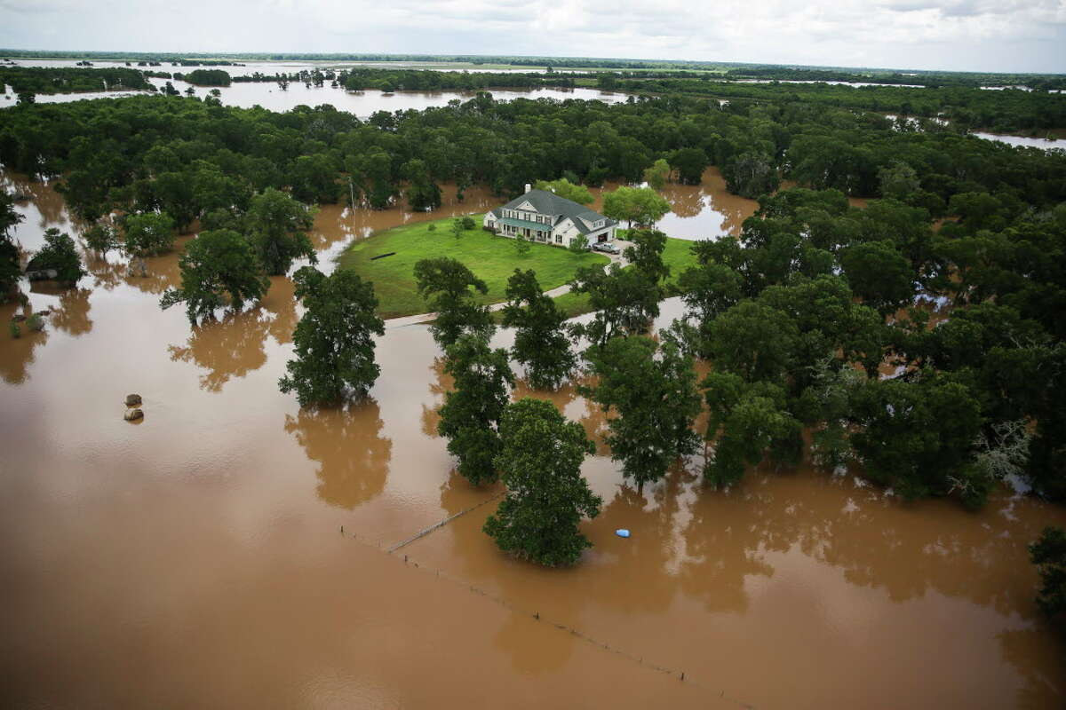 Aerial photos capture cowboys, flooded homes as floods plague Houston