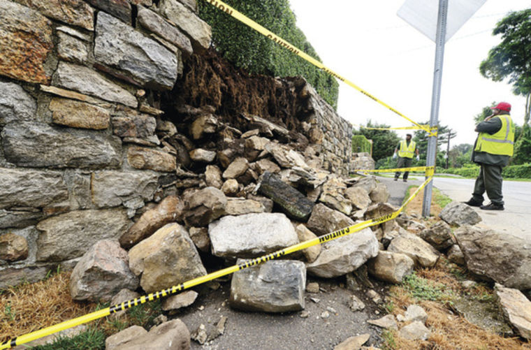 Nearly two inches of rain flood streets, collapse retaining wall