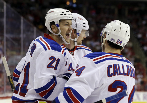 Rangers claim playoff spot by beating Canes