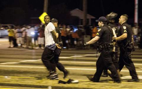 Photo of protester in dress, police in riot gear hailed as 'powerful'