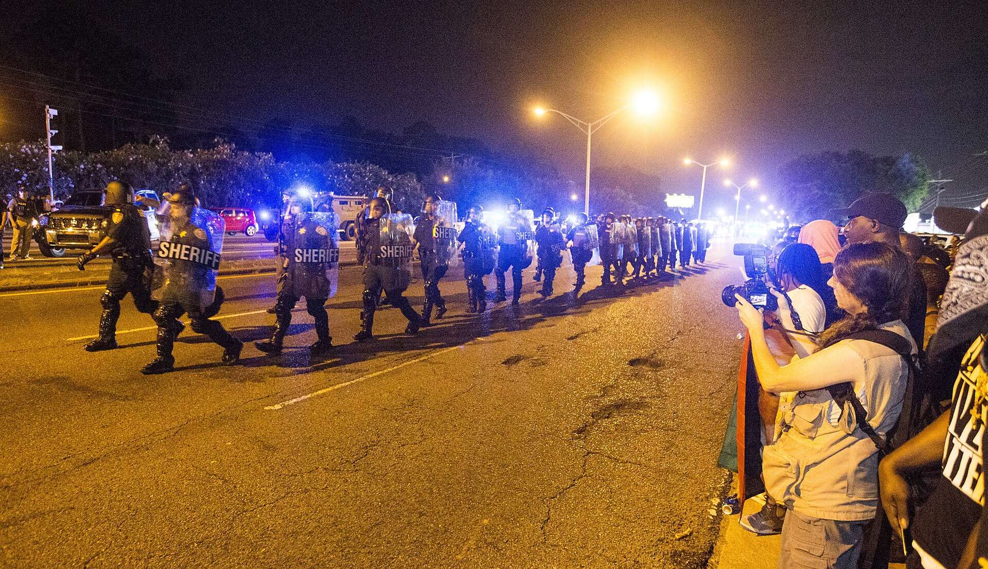 Photo of protester in dress, police in riot gear hailed as 'powerful'