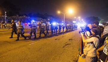 Photo of protester in dress, police in riot gear hailed as 'powerful'