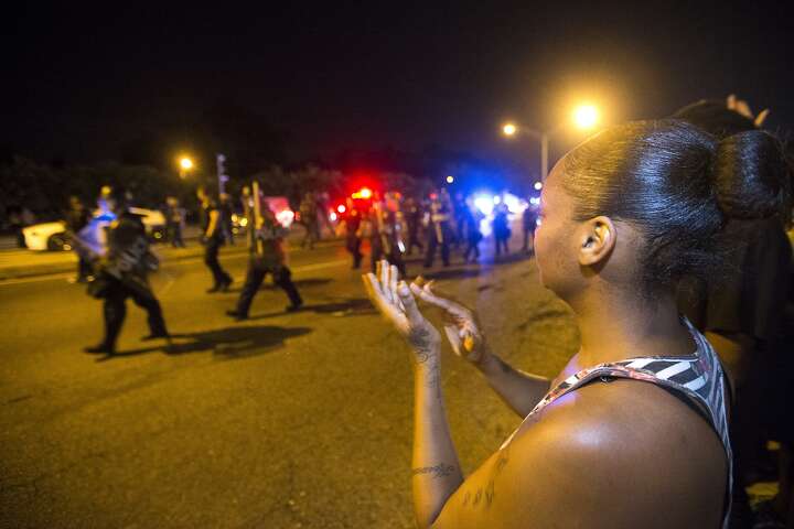 Photo of protester in dress, police in riot gear hailed as 'powerful'