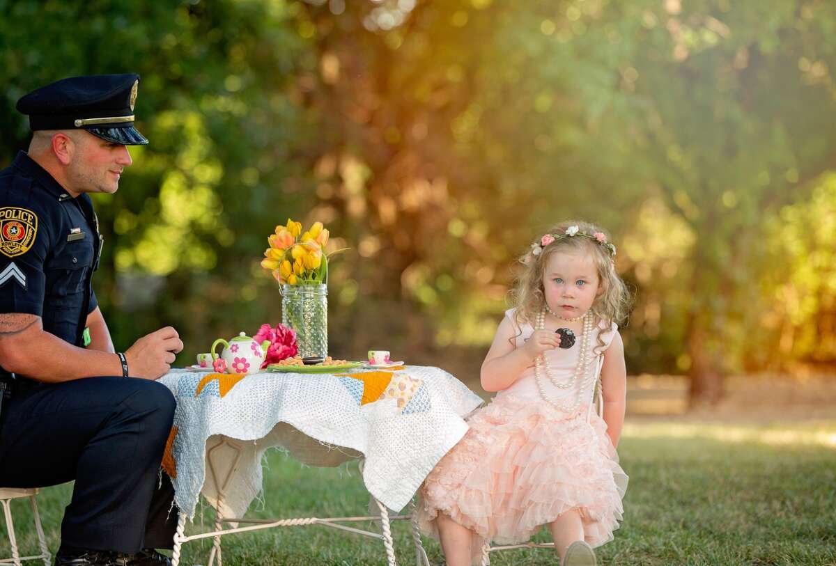 Police officer has tea time with little girl whose life he saved