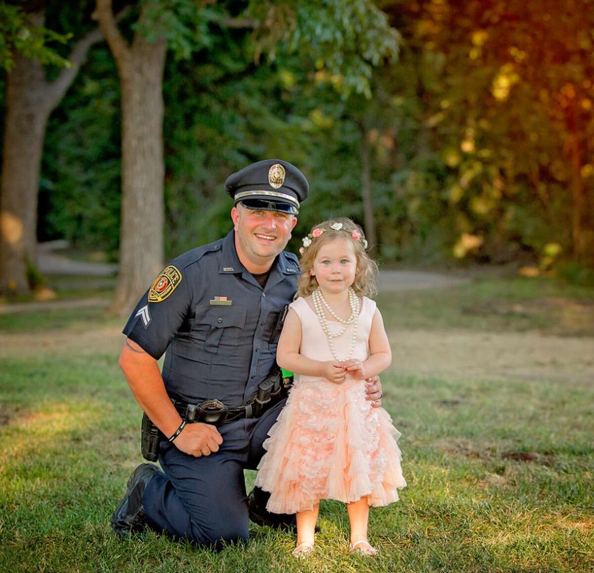 Police officer has tea time with little girl whose life he saved