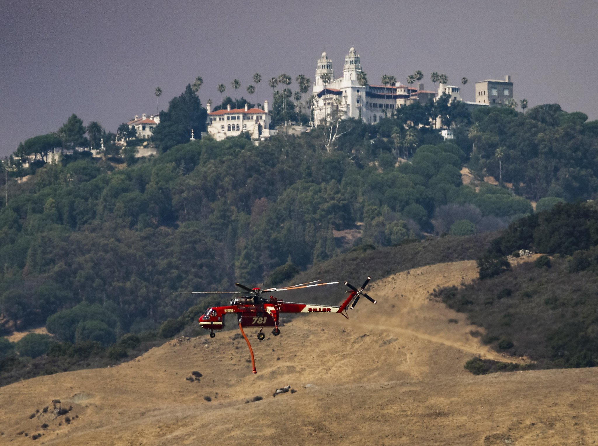 Crews scramble to protect Hearst Castle from fire, smoke