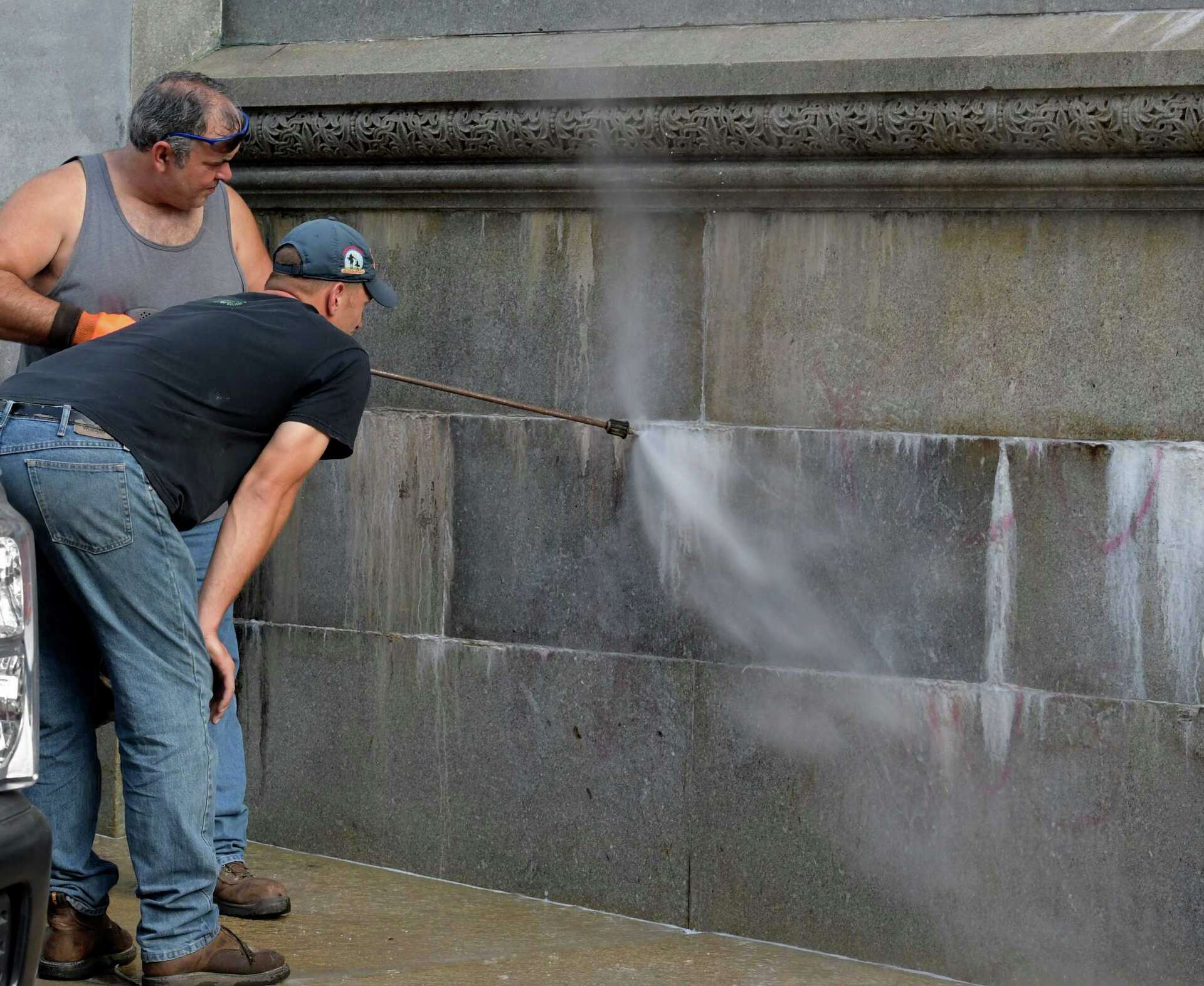 Vulgar graffiti and anarchy symbol spray-painted on Capitol building
