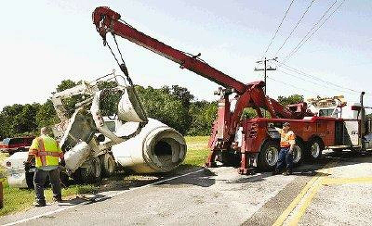 Driver suffers minor injuries in concrete truck rollover