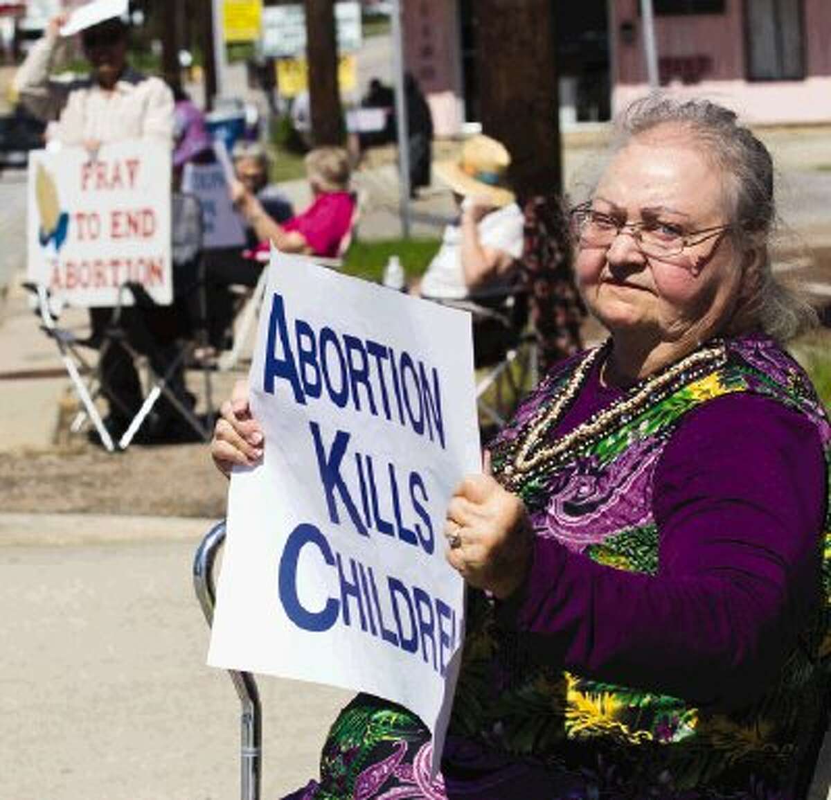 Pro-life volunteers pray along Frazier Street in Life Chain