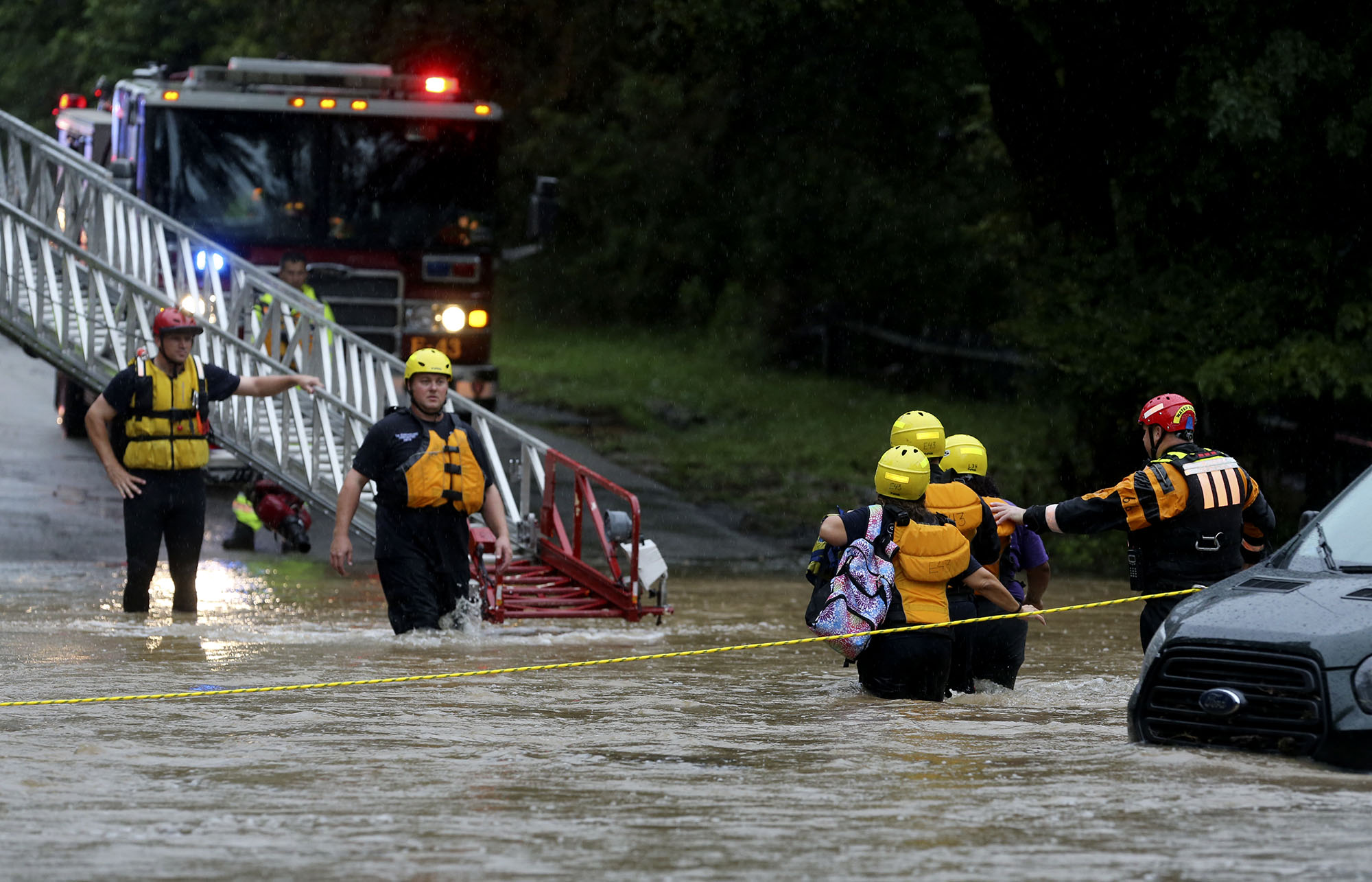 Photos: Firefighters rescue 'special-needs' passengers from flooding ...