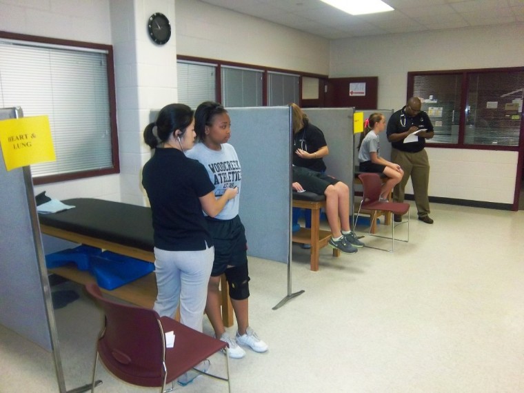 Student athletes receive physicals from health professionals