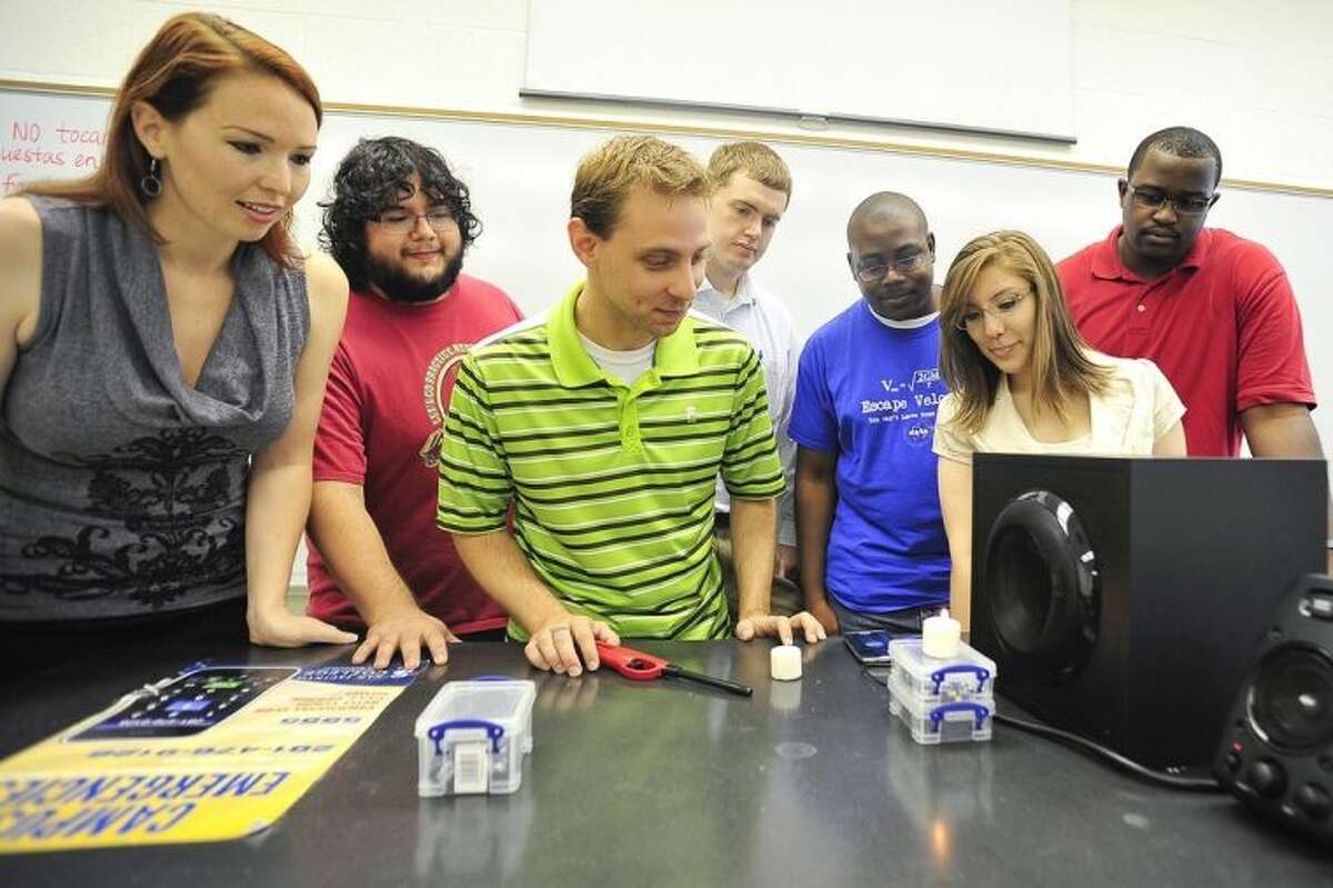 Student-faculty research team learning how sound can put out fires