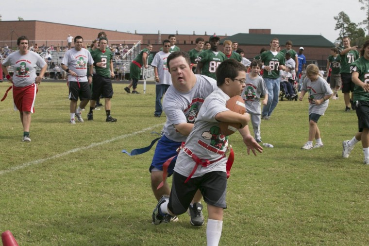 The Woodlands players interact with special needs athletes at ...