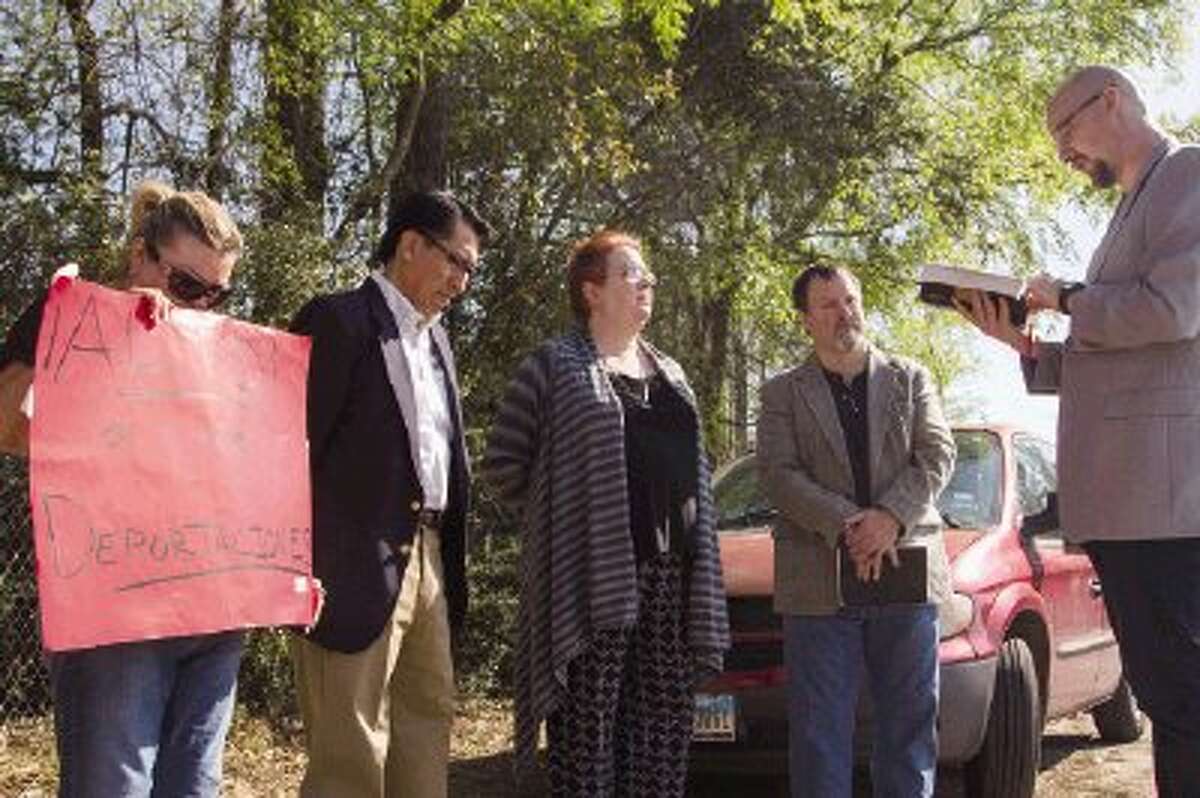 Protestors pray outside Corley Center