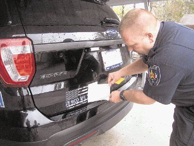 Roman Forest Police Department places decals on vehicles
