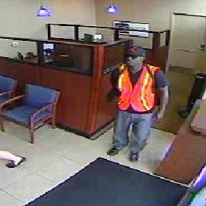 Armed Chase Bank robber in bright vest bags cash