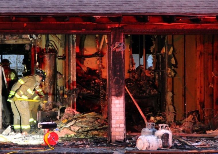 Propane canister explosion injures man grilling inside his garage