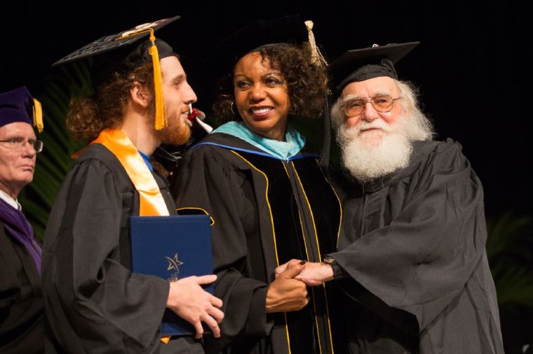 83-year old man graduates college with son