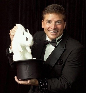 Magician performing for elementary-aged student at First Colony Library