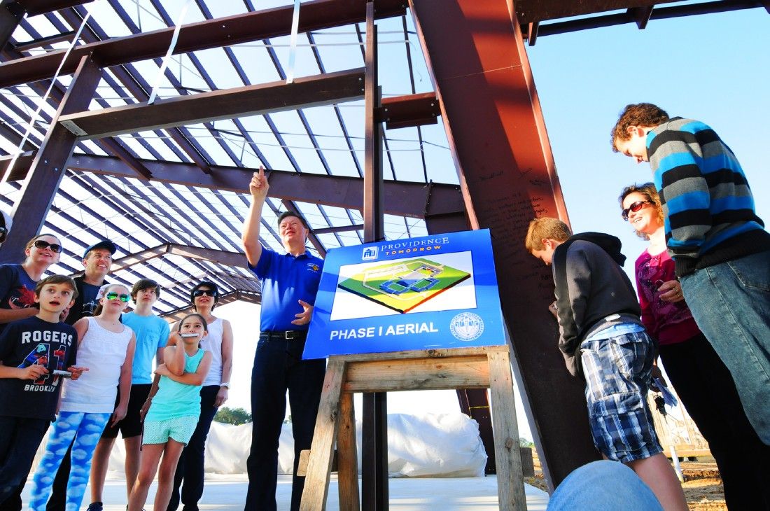 Community joins together at beam-signing event for school