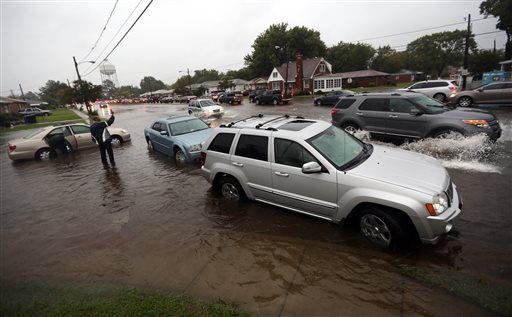 Stalled front and tropical storm deluge roads, close schools