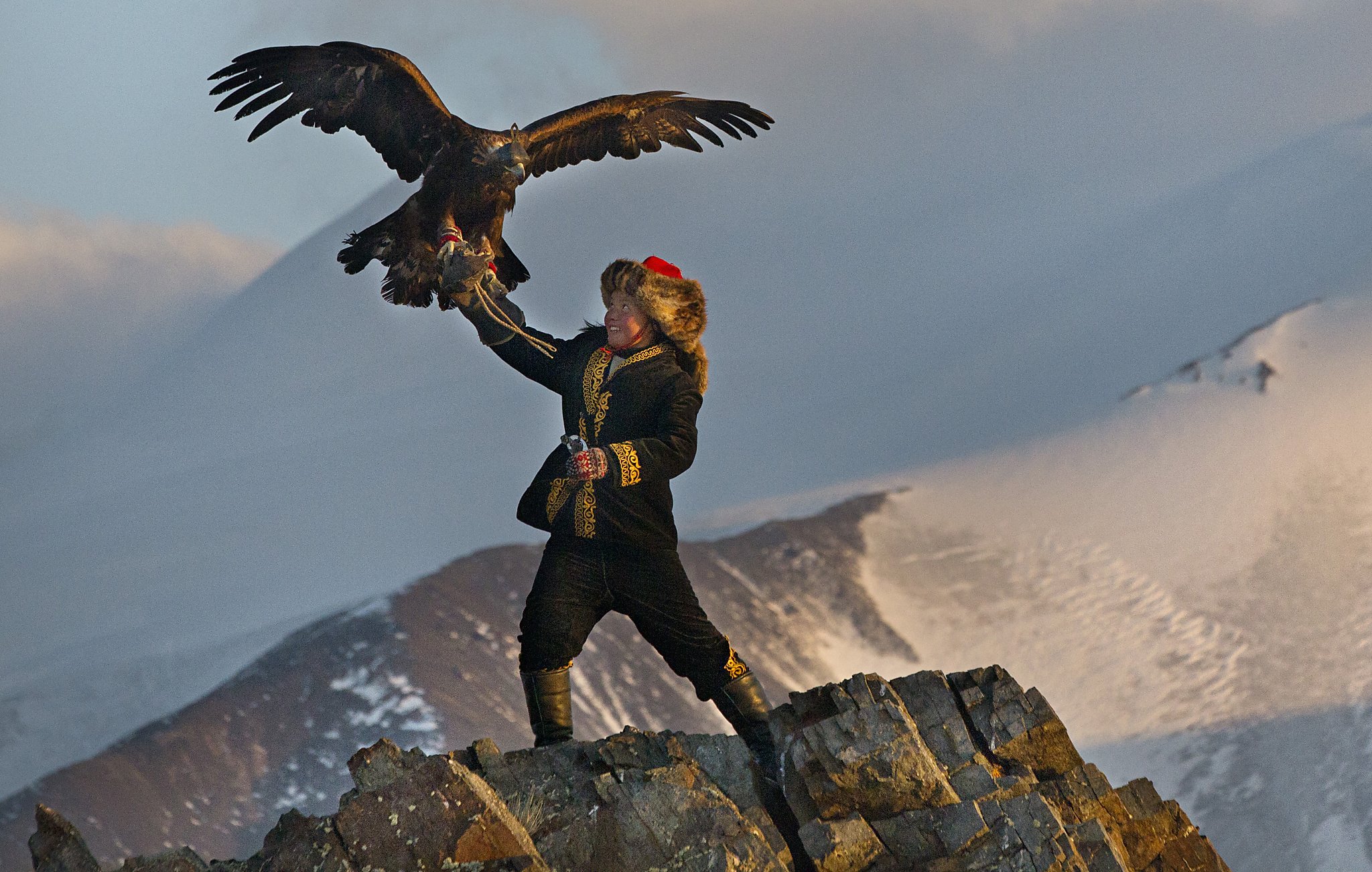 Exhilarating portrait of a girl who hunts using an eagle