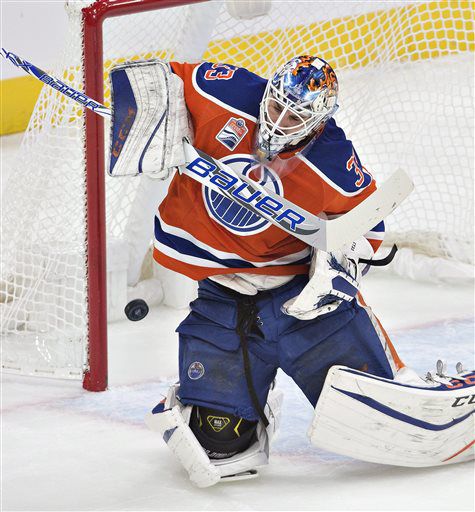 McDavid scores twice, Oilers beat Flames 7-4 in new arena