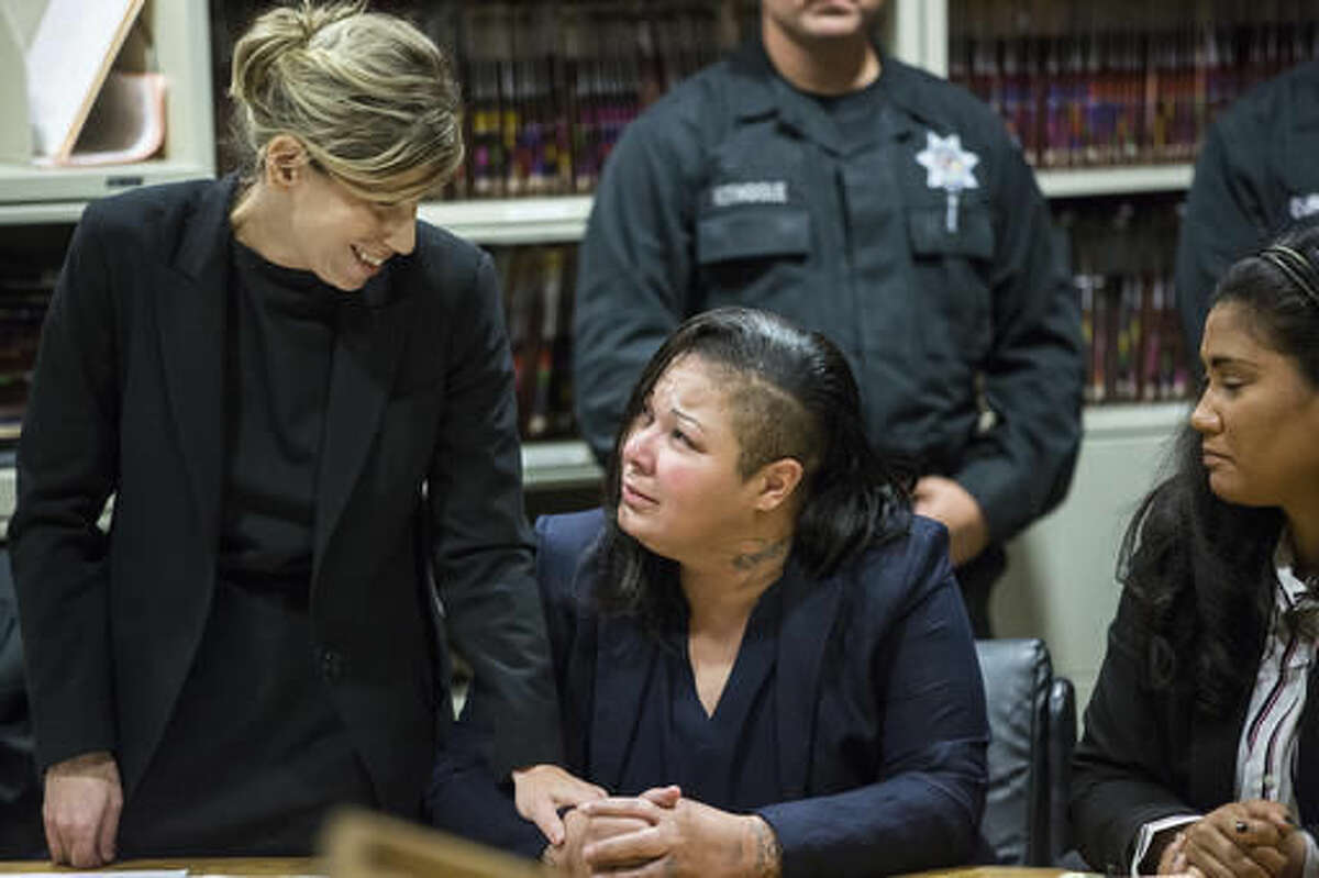 Judge resentences woman to 63 years for 1992 gang killings