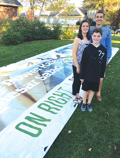 Siblings collecting billboard material