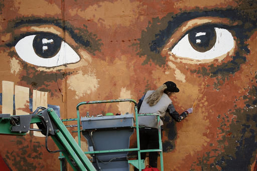 Mural of kids brightens wall dividing Cleveland neighborhood