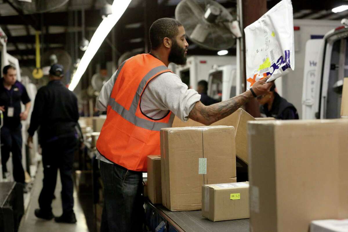 FedEx workers race to meet record demand