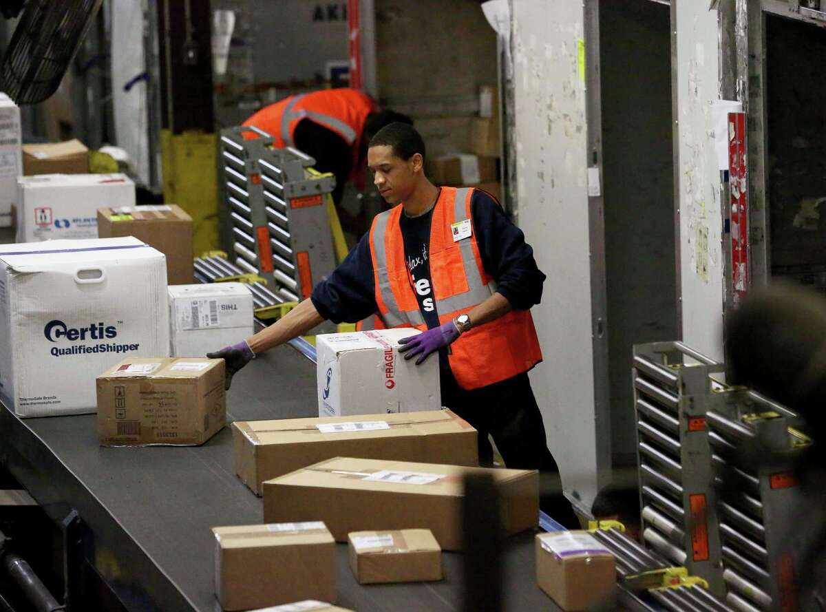 FedEx workers race to meet record demand