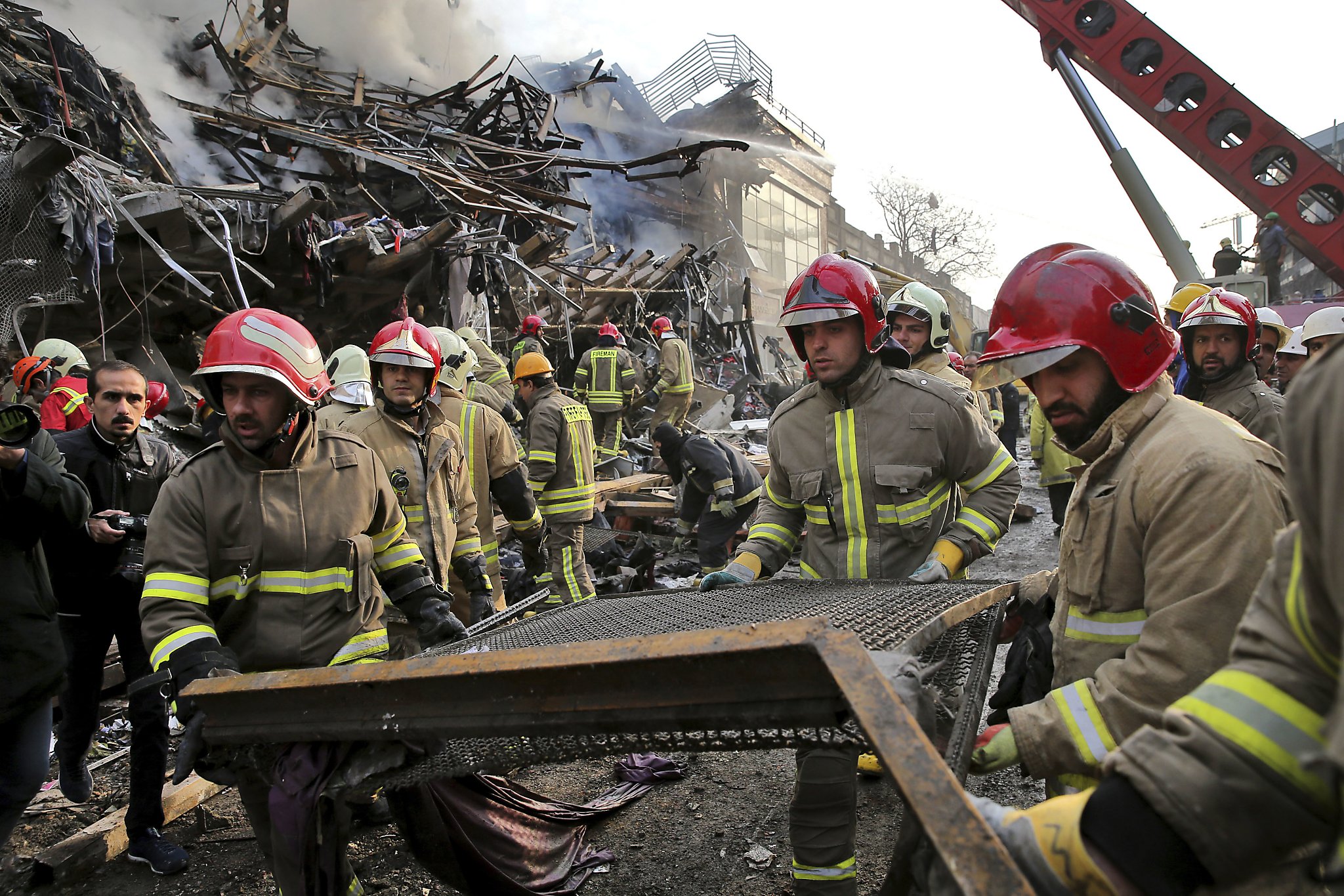 Many victims sought in rubble of deadly Iran building collapse