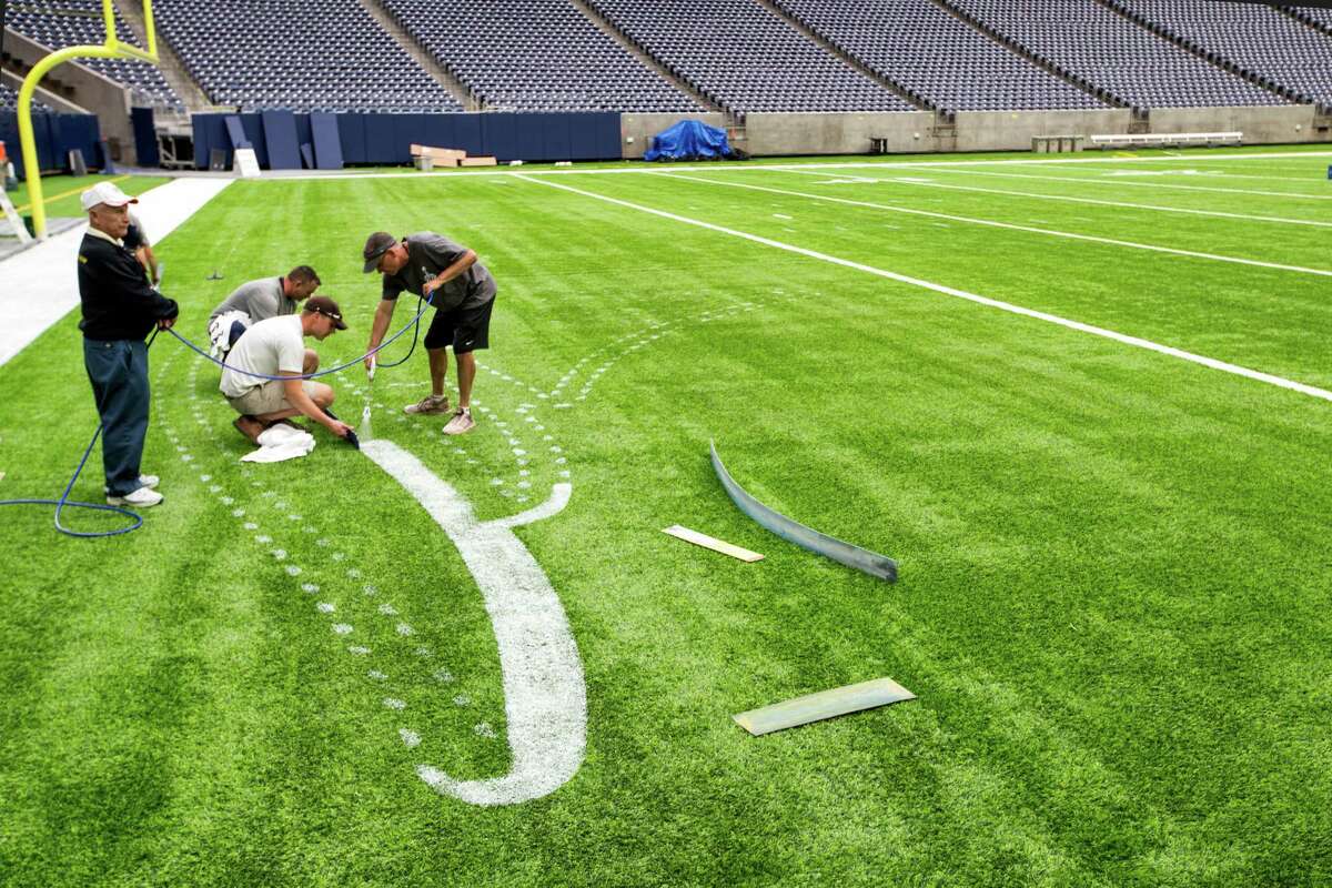 Super Bowl turf is laid, but check still in mail