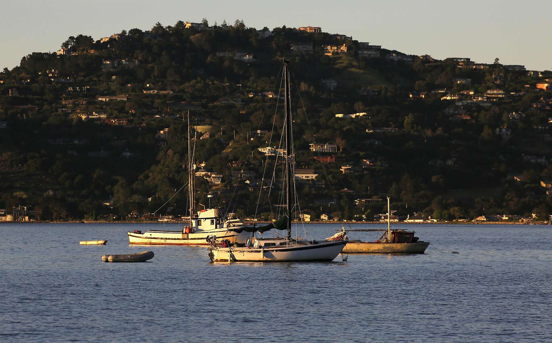 As more ‘anchor-outs’ live on SF Bay, tension mounts on land