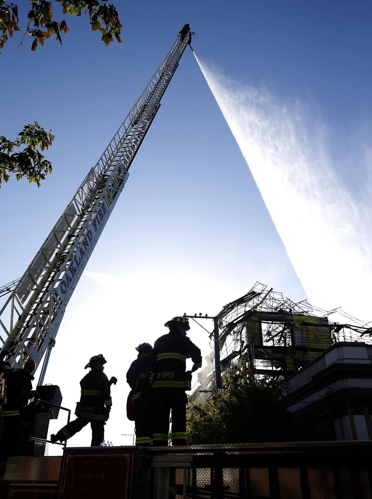 Fire crews work on still-smoldering debris from Emeryville complex