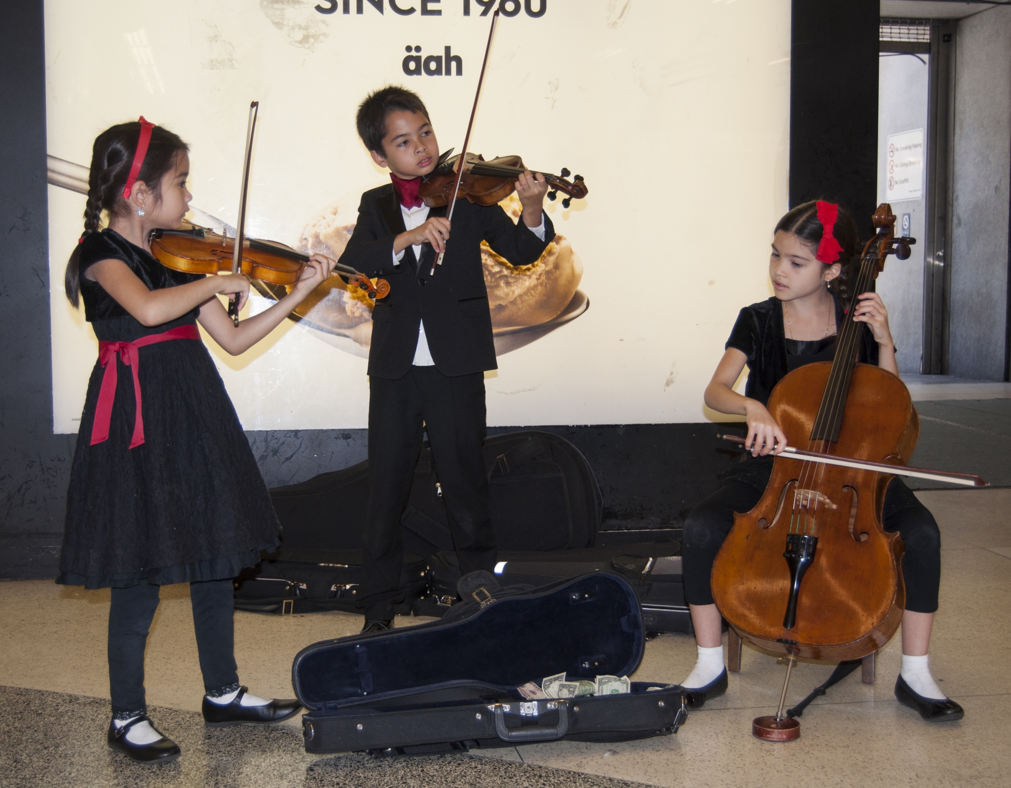 Children busking at Powell St. BART amaze commuters