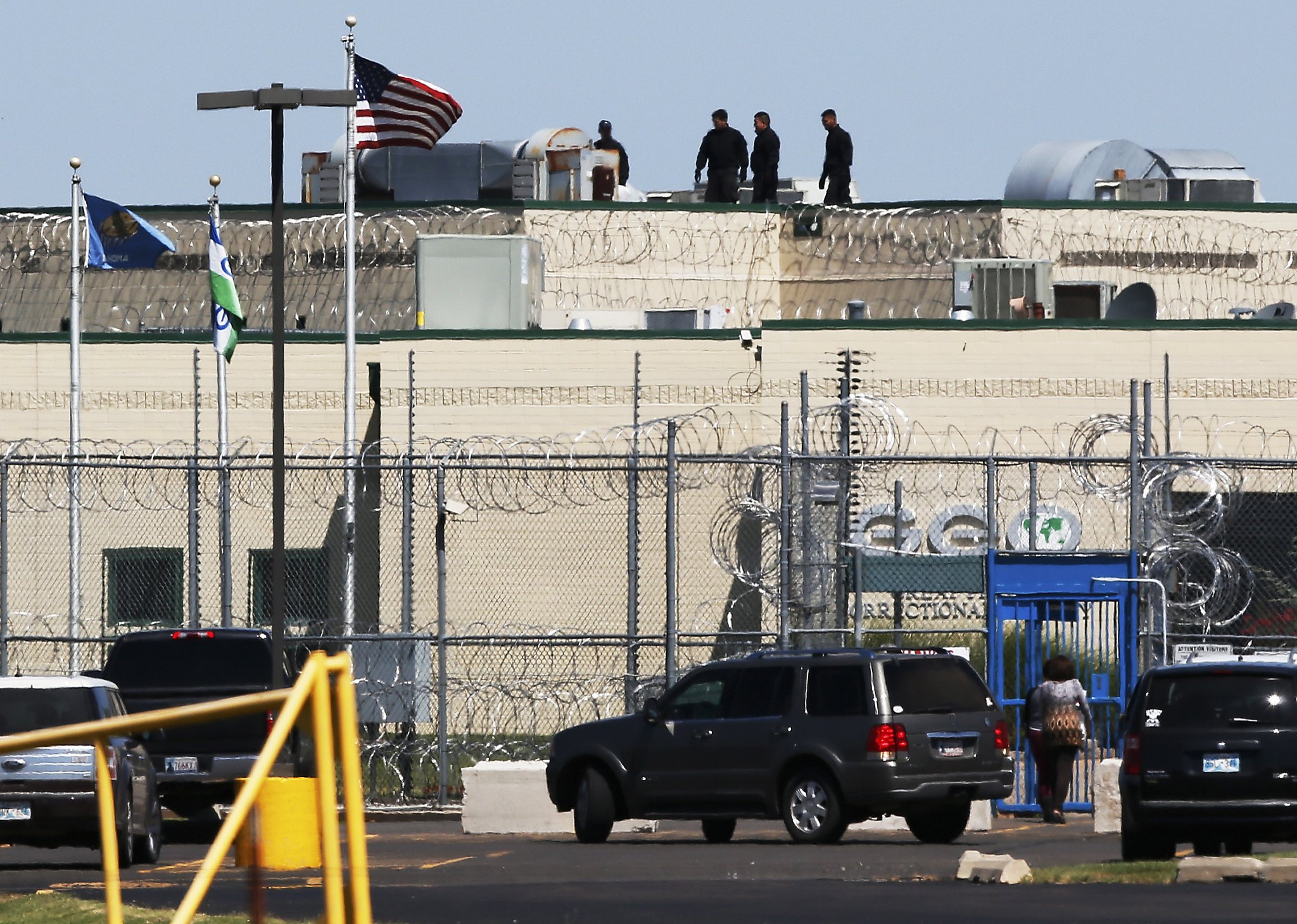 Oklahoma inmates take 2 guards hostage in prison riot
