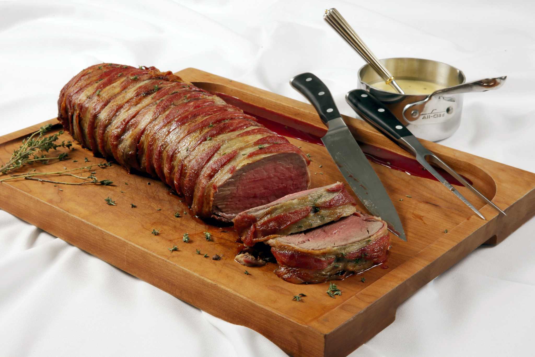 Recipe for bacon-wrapped beef tenderloin with green peppercorn thyme sauce