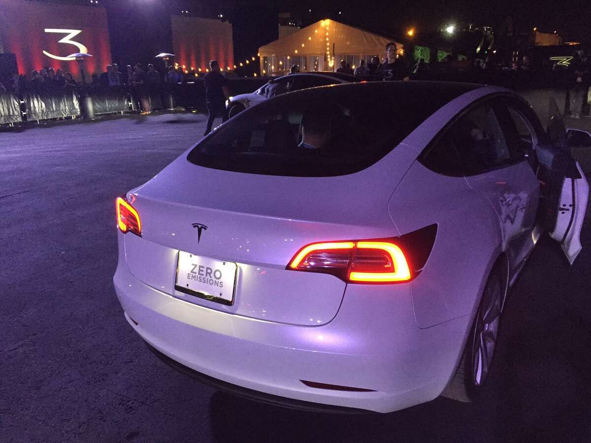 Elon Musk hands over the 1st Tesla Model 3s, and reveals its secrets