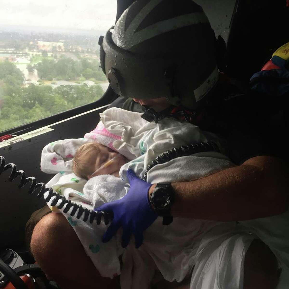 Stunning photo of coast guard rescuing infant during Harvey