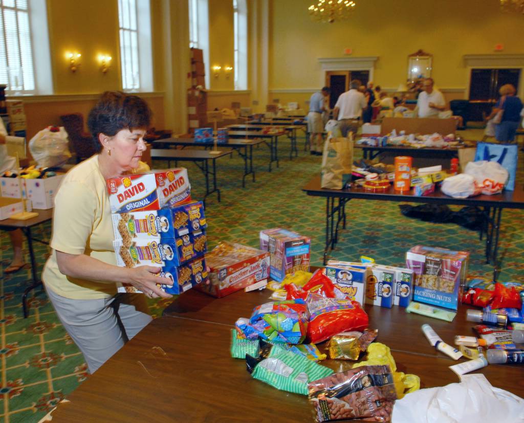 Volunteers help prepare donations for overseas troops