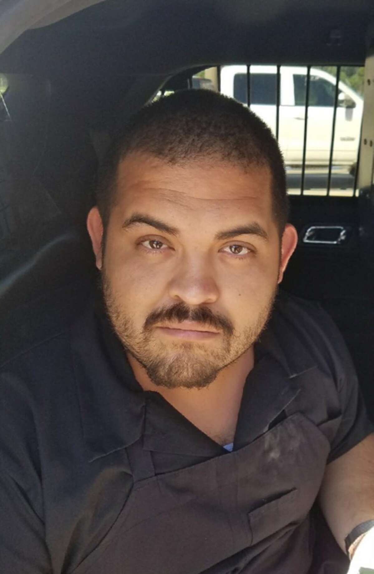 Uber driver yells out to reporters while being booked on sex assault charge