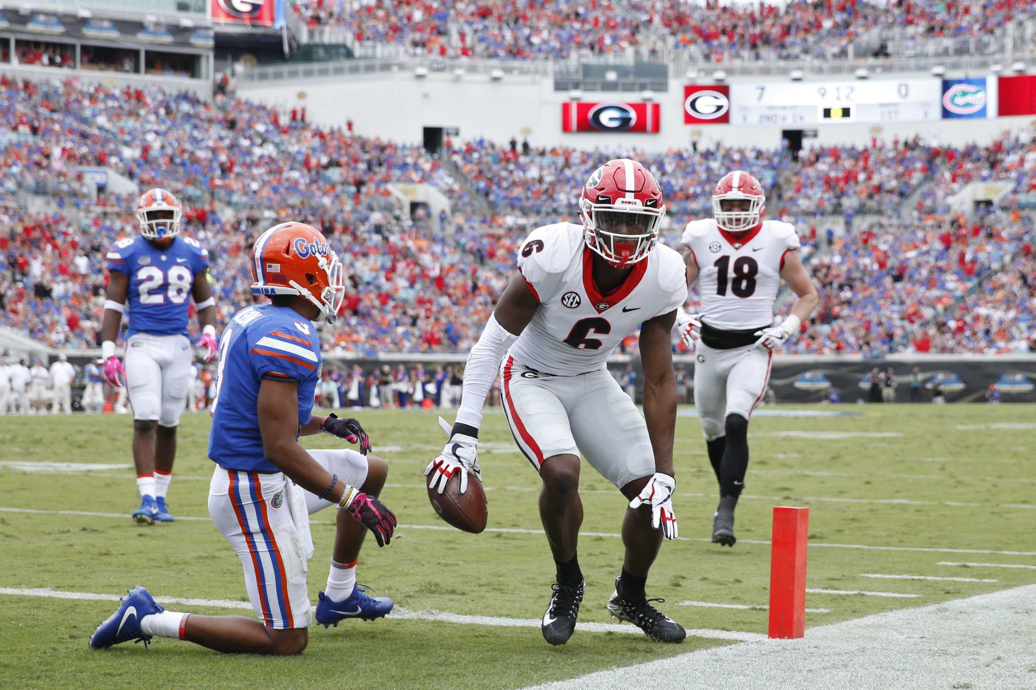 SEC rivals atop playoff rankings