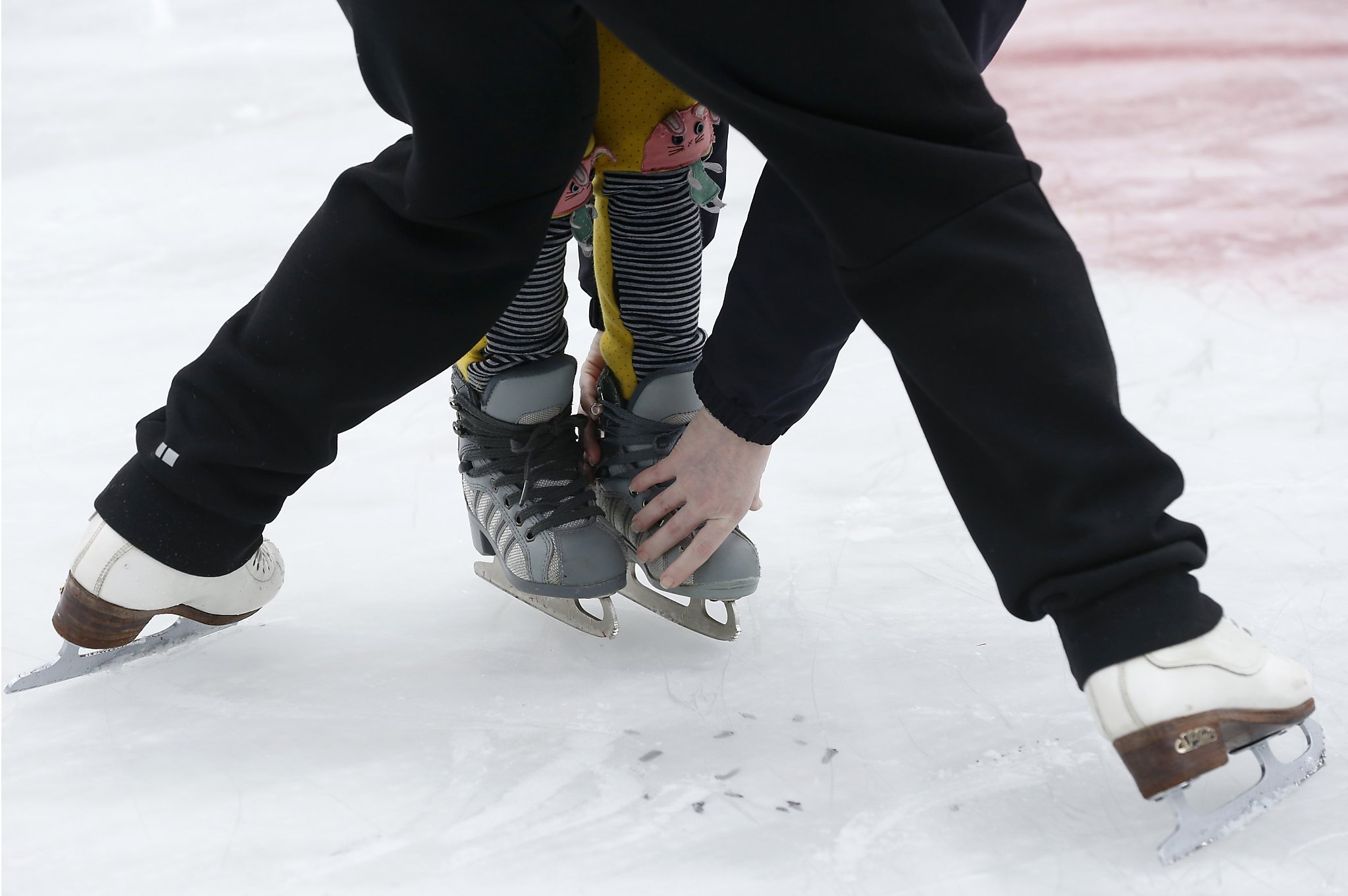 Beginning skaters venture out on the ice at Union Square Rink in SF