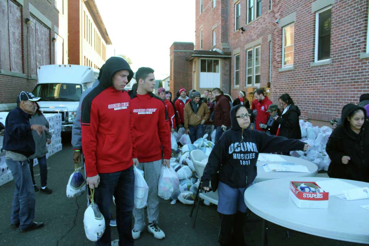Sacred Heart students pass out turkeys to Bridgeport families in need