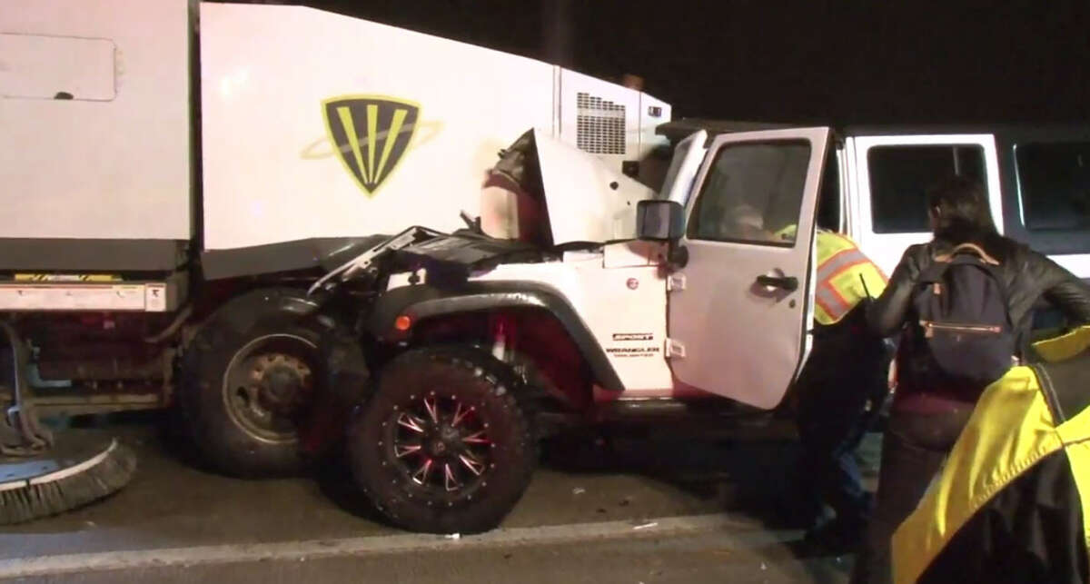 Man injured after Jeep crashes into street sweeper vehicle shrouded in ...